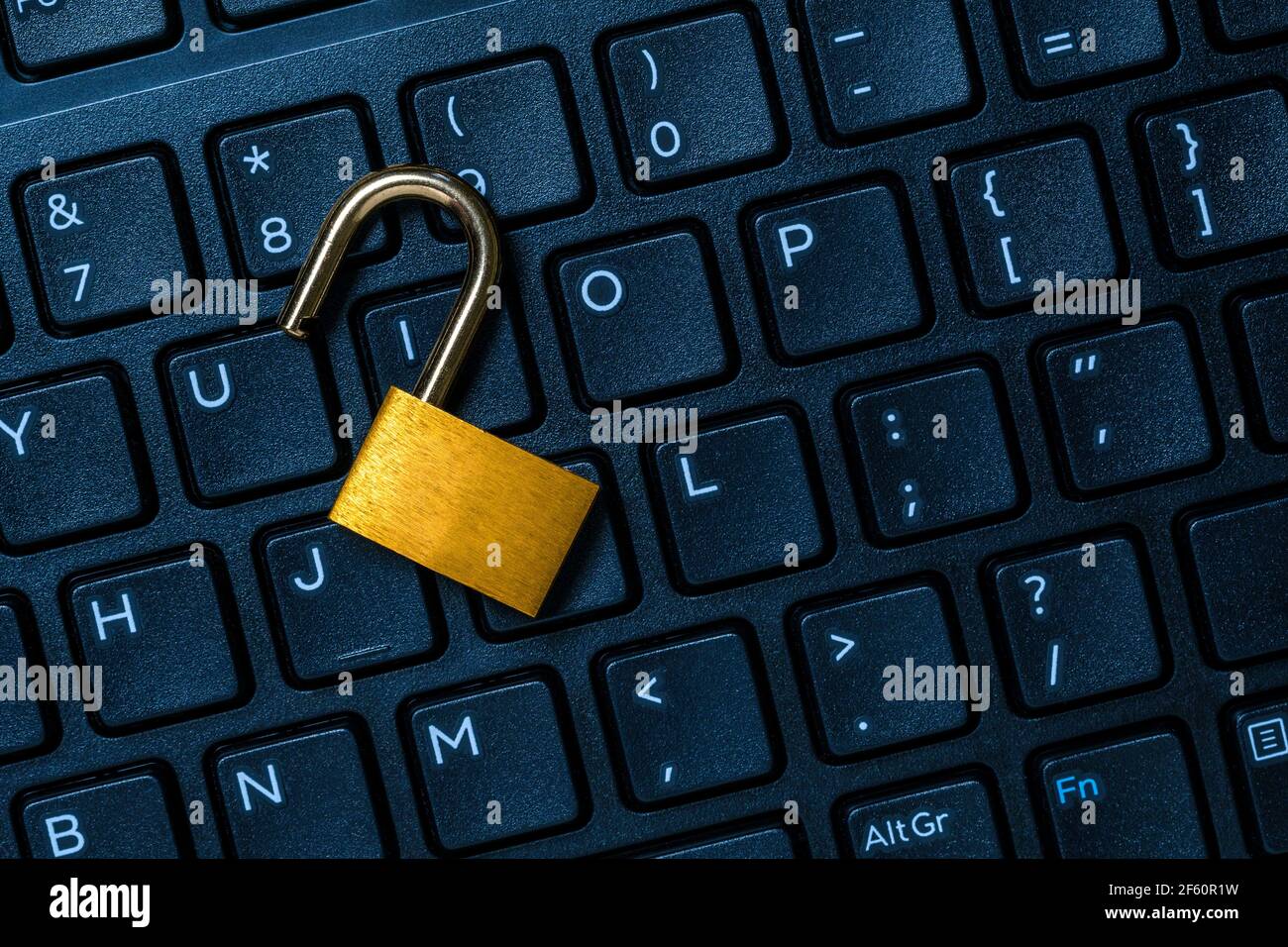 Unlocked security lock on computer keyboard - computer security breach ...