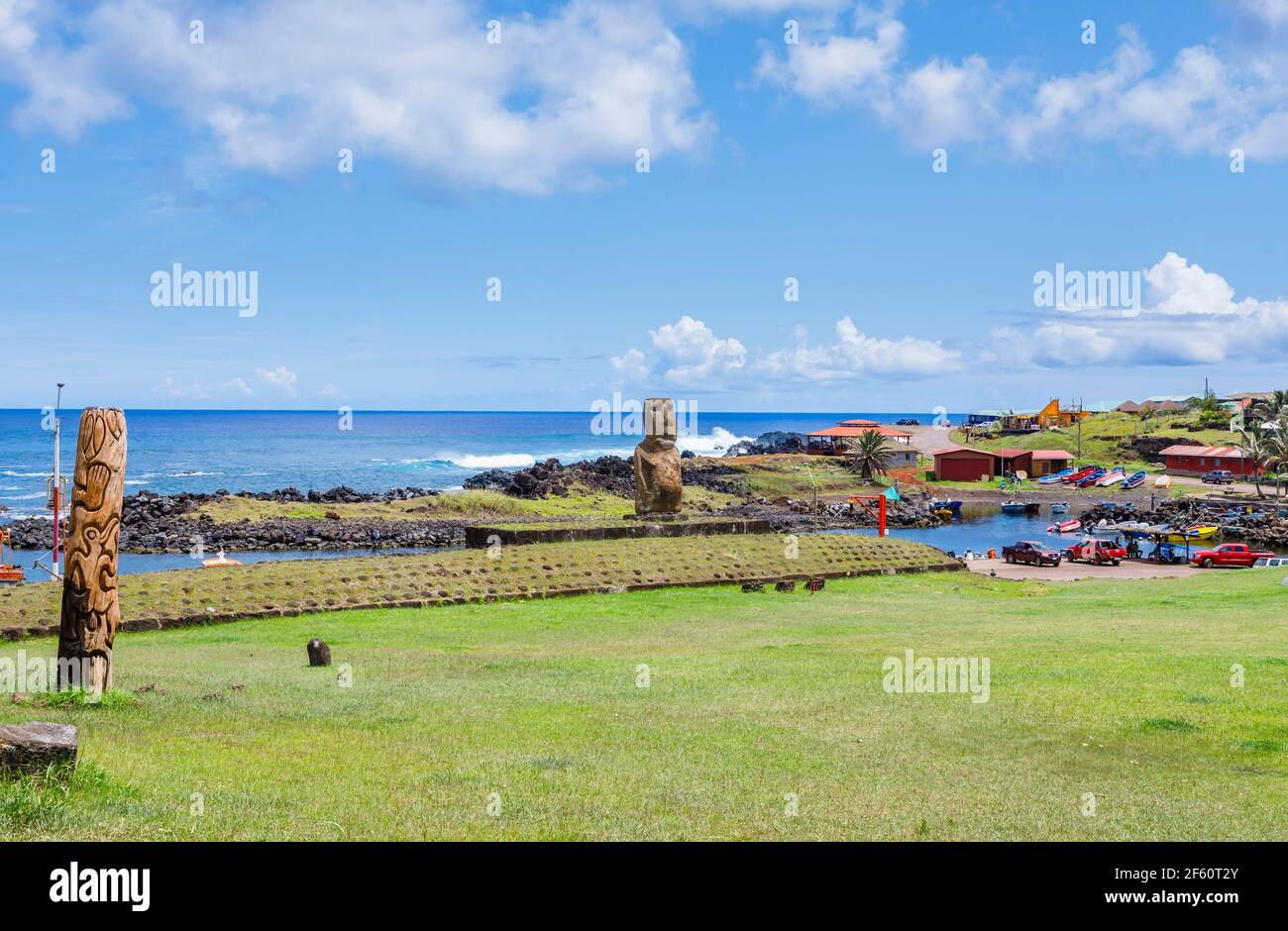 Weathered single moai (statue) standing facing away from the sea in ...