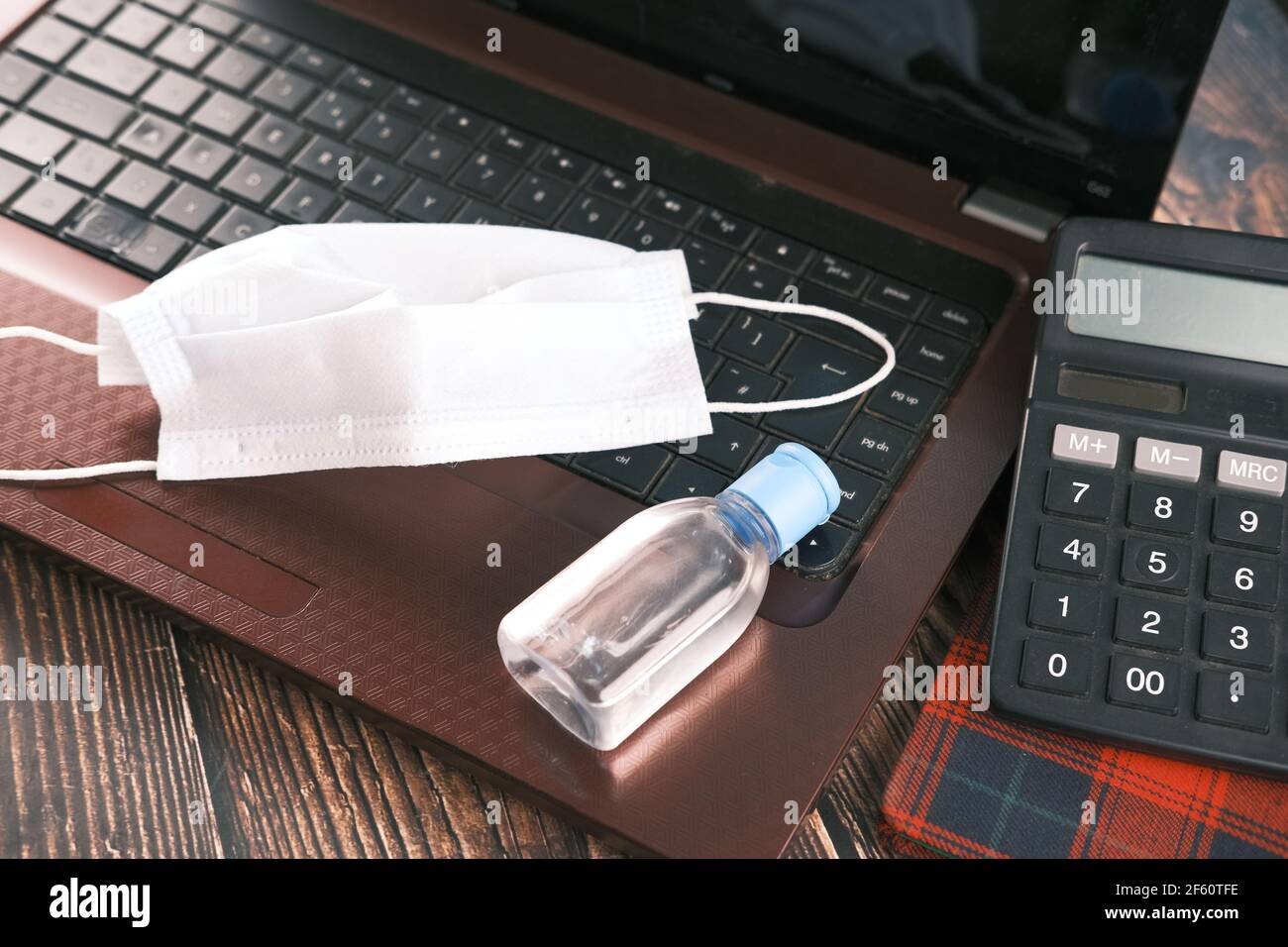 Surgical masks, hand sanitizer on office desk Stock Photo - Alamy