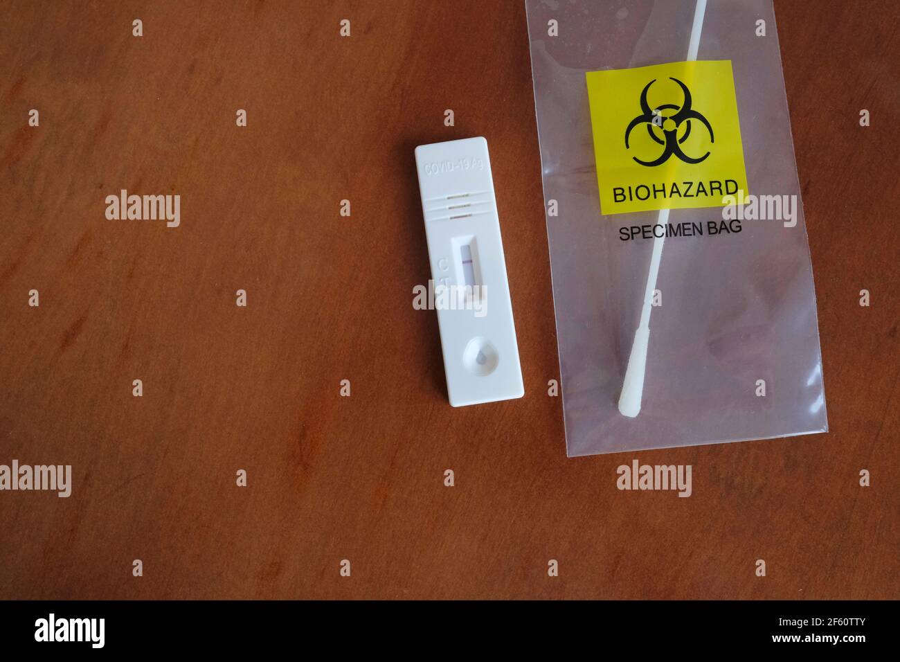 Coronavirus (COVID-19) rapid test with negative result next to a nasal ...