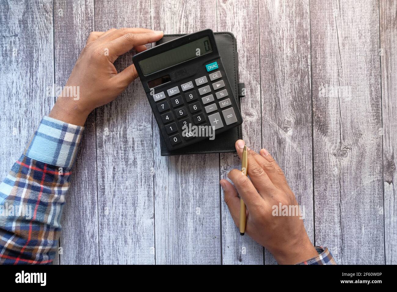 top view of man hand using calculator Stock Photo - Alamy