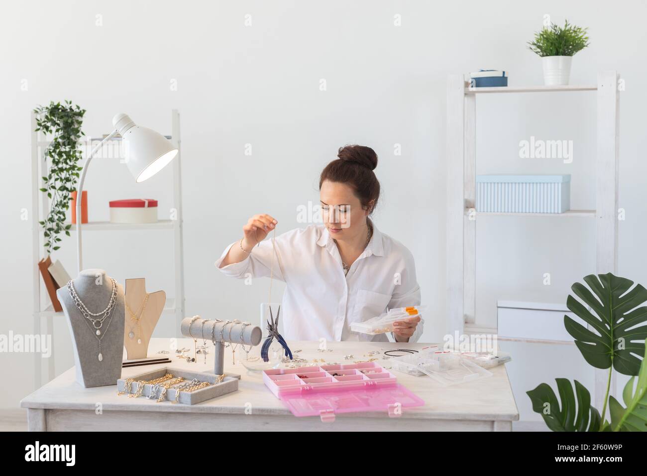 Professional accessories designer making handmade jewelry in studio ...