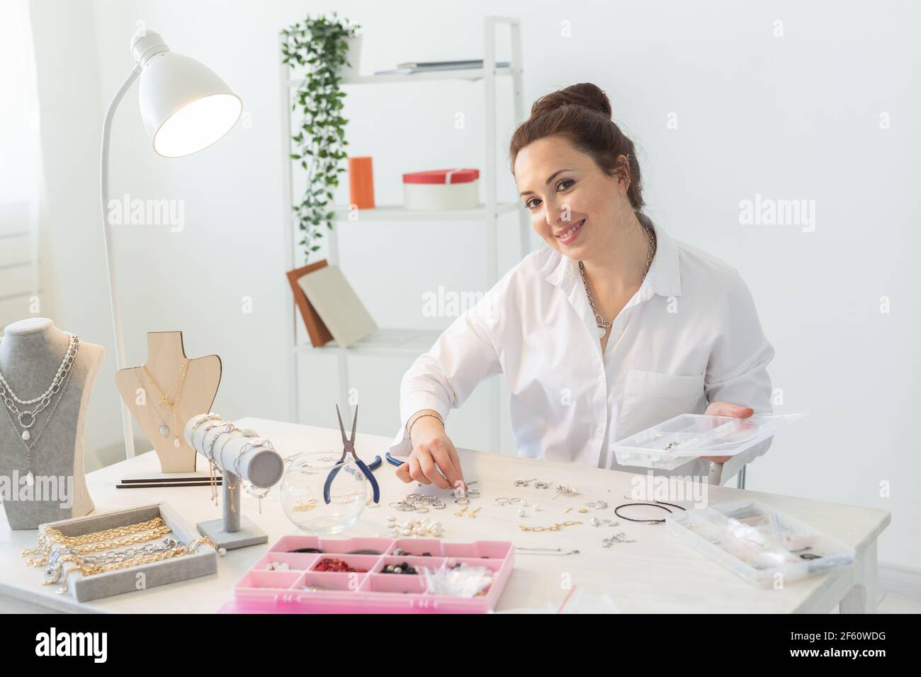 Professional jewelry designer making handmade jewelry in studio ...