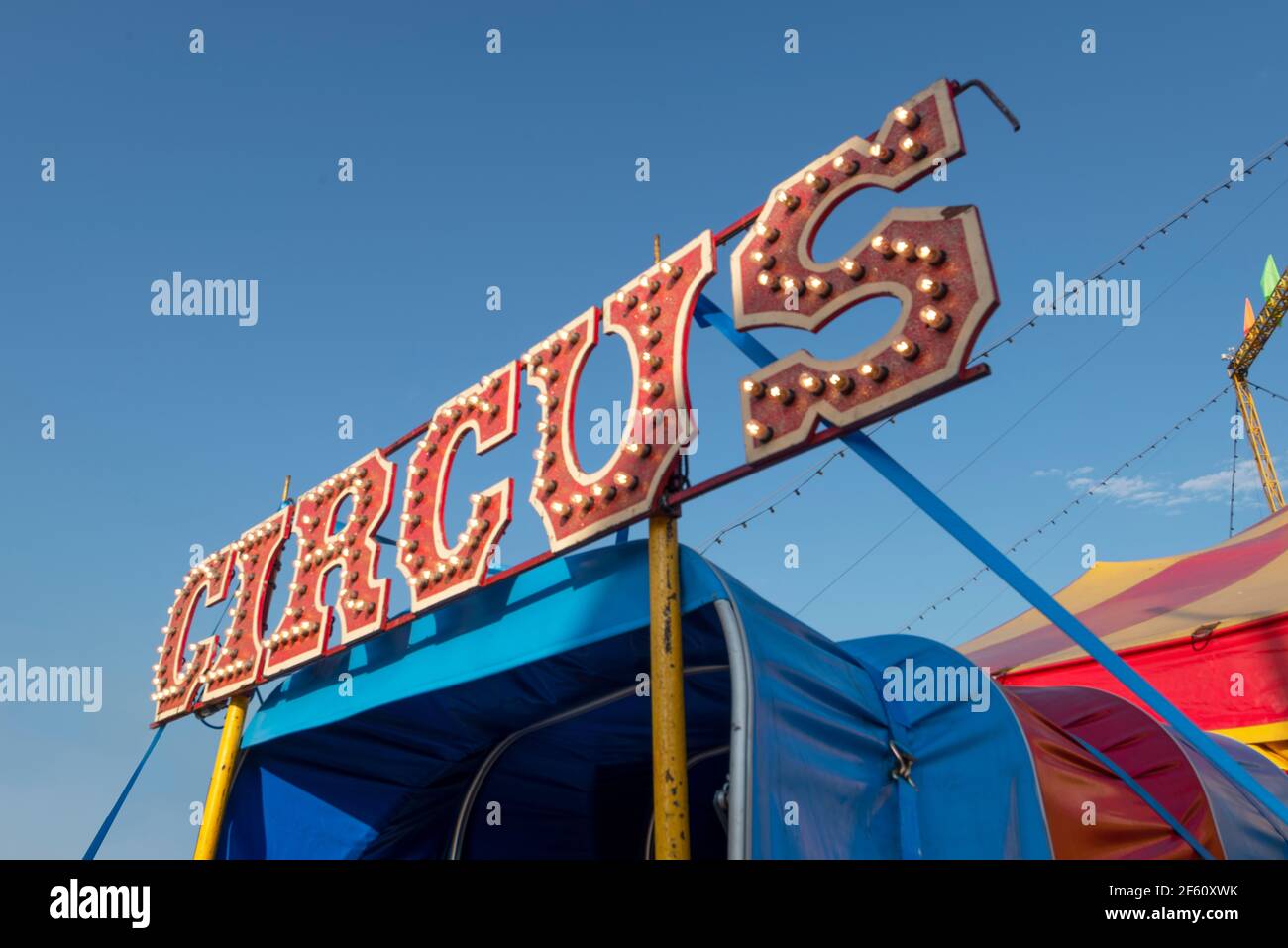 Circus sign outside a big top with blue sky behind Stock Photo - Alamy