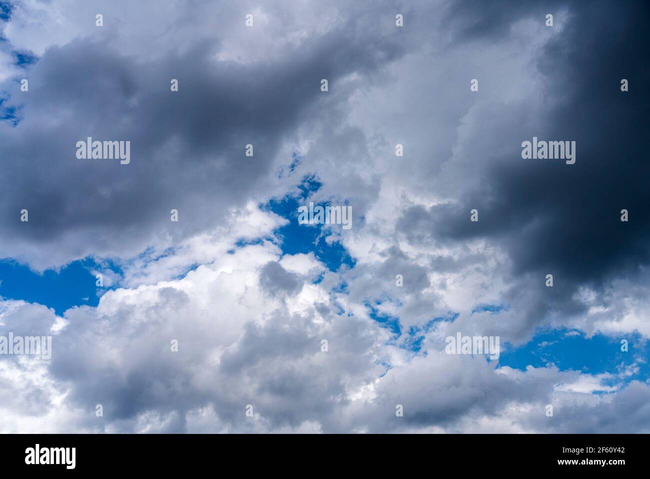 Background image, dark clouds against a blue sky Stock Photo - Alamy
