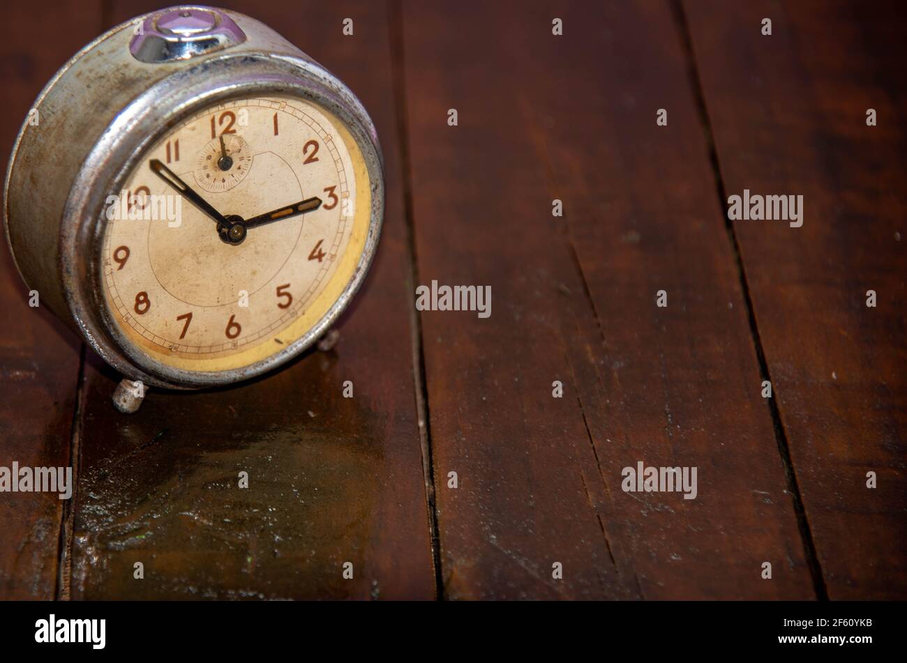 Old and retro alarm clock on wooden surface. Vintage background. Decor ...