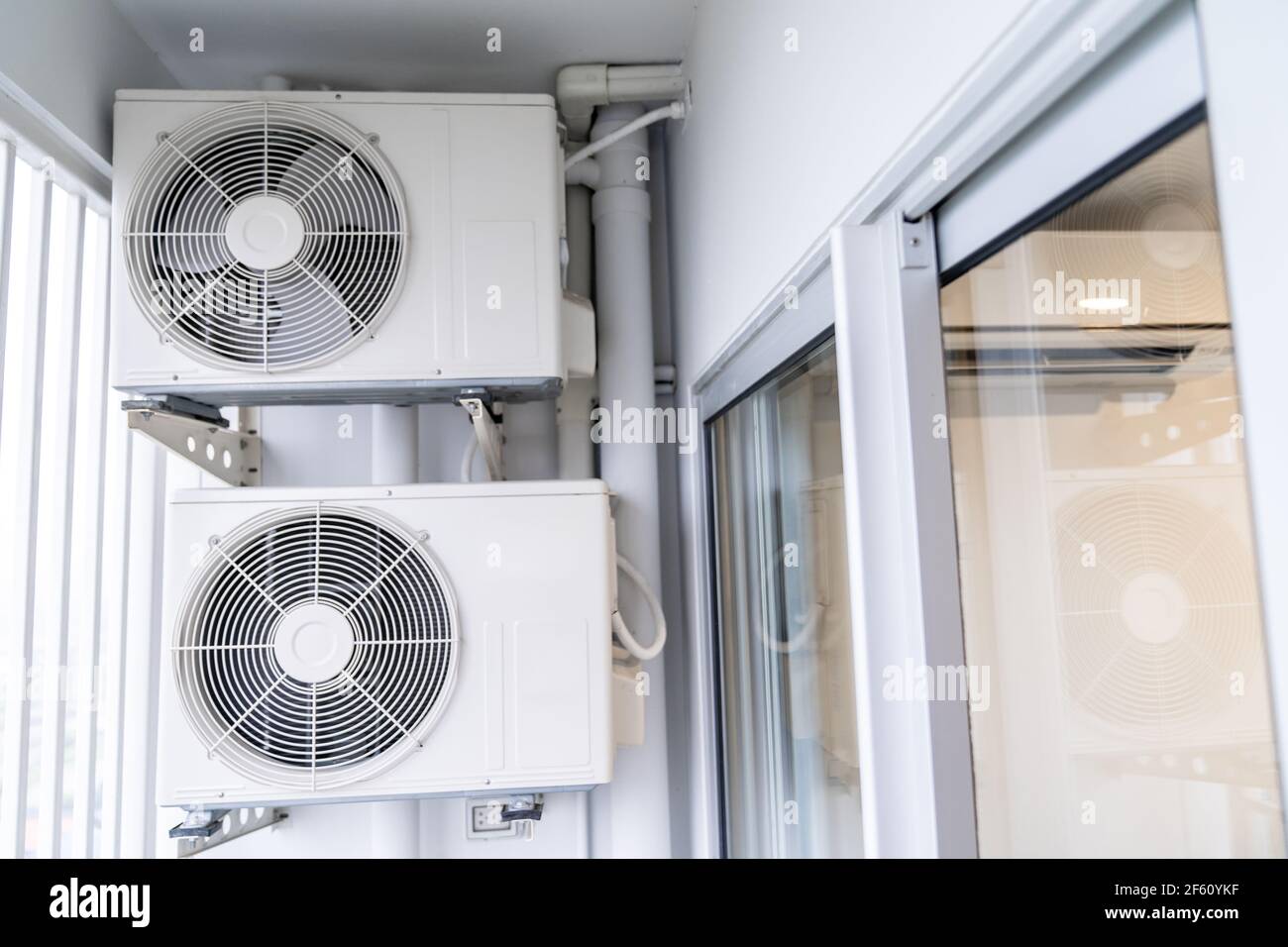 two air conditioning compressors are hung on wall Stock Photo - Alamy