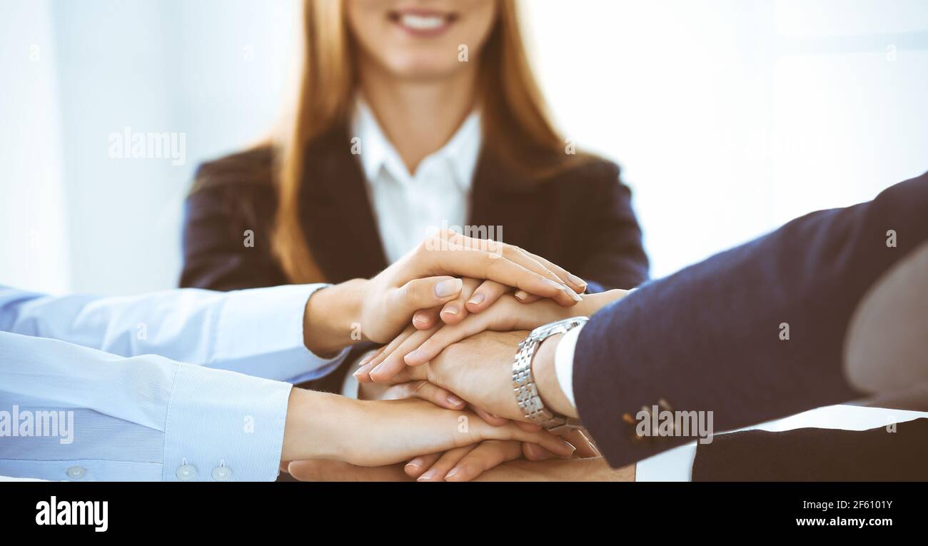 Business team showing unity with their hands together. Group of people ...
