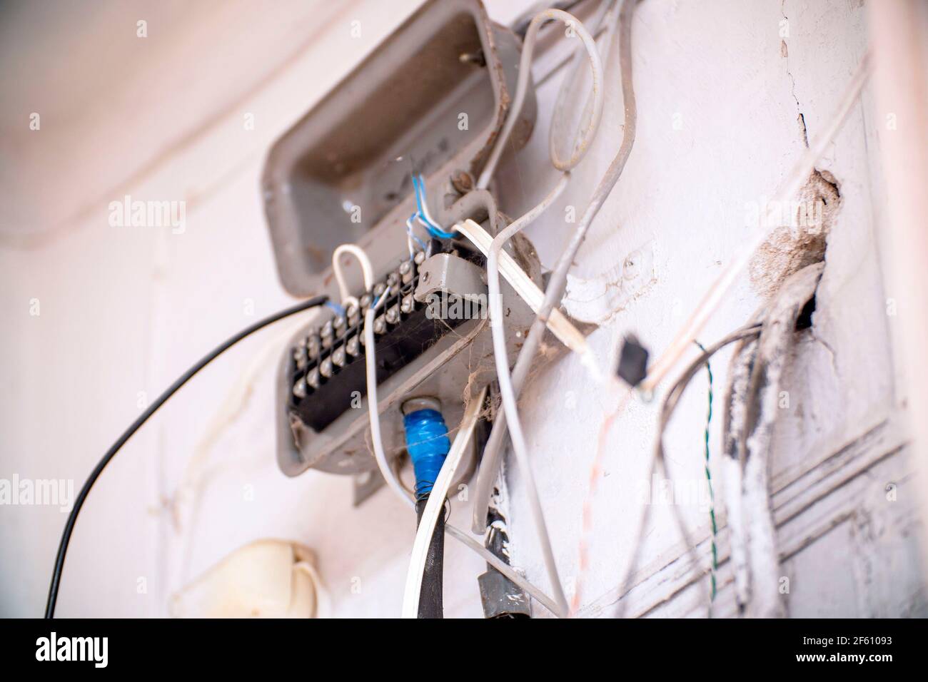 An old junction box with wires on a light wall. Selective Focus Stock ...