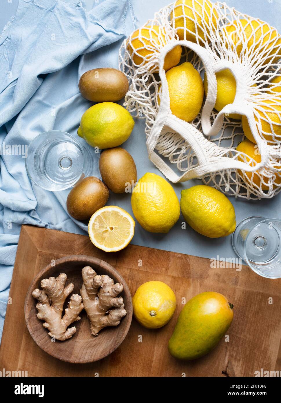 Citrus fruits in net bag with ginger roots Stock Photo - Alamy