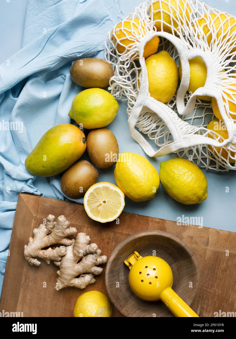 Citrus fruits in net bag with ginger roots Stock Photo - Alamy