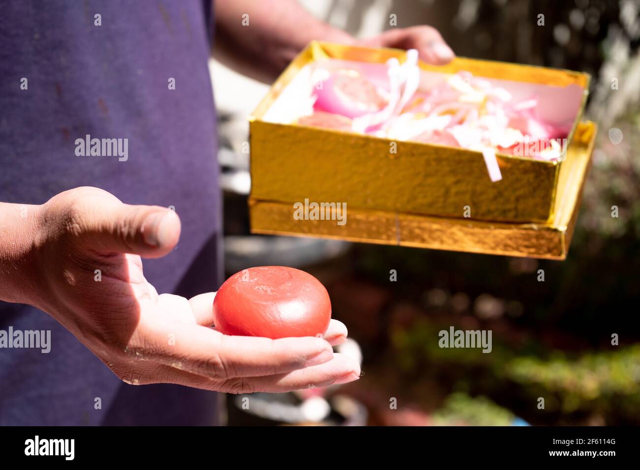 young indian man carrying gulal gota powder sphere which is made of ...