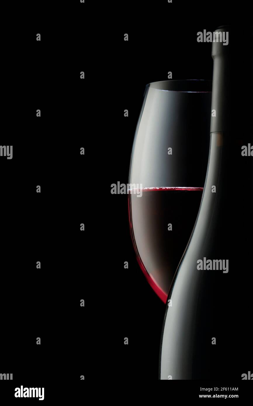 the contours and curves of a bottle and a glass of red wine. a concept ...
