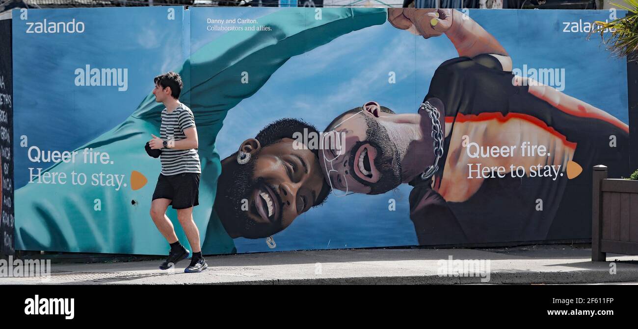 Members of the public pass a new mural painted by artists Cormac Dillon ...