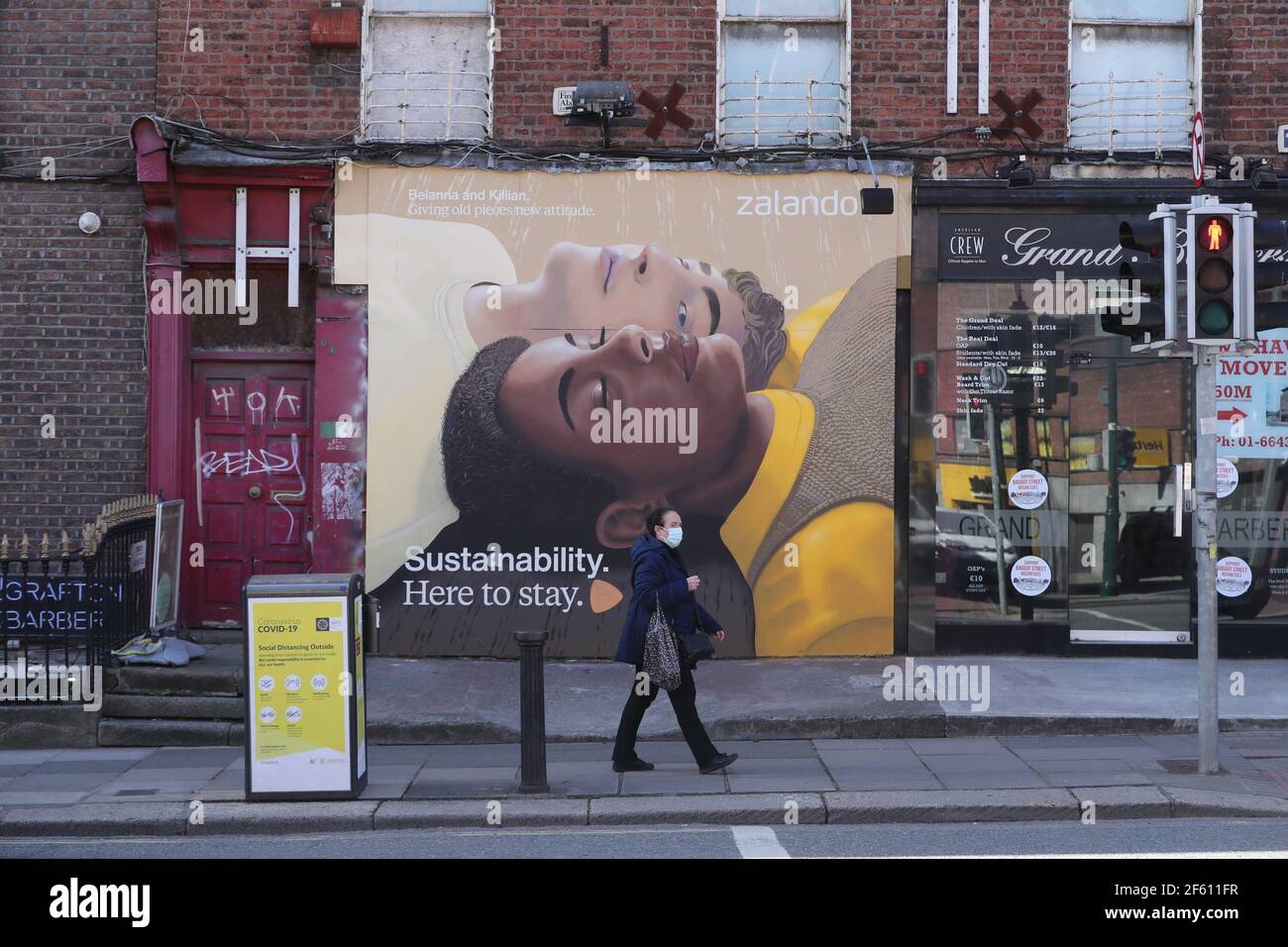 Members of the public pass a new mural painted by artists Cormac Dillon ...