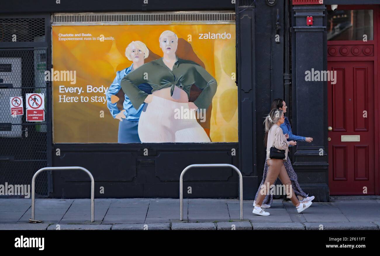 Members of the public pass a new mural painted by artists Cormac Dillon ...