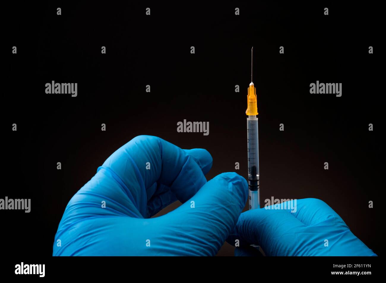 Flu shot vaccine and hypodermic needle inoculation concept with hands ...