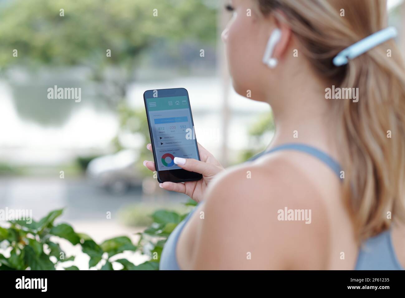 Young woman using application on smartphone when controlling her weight ...