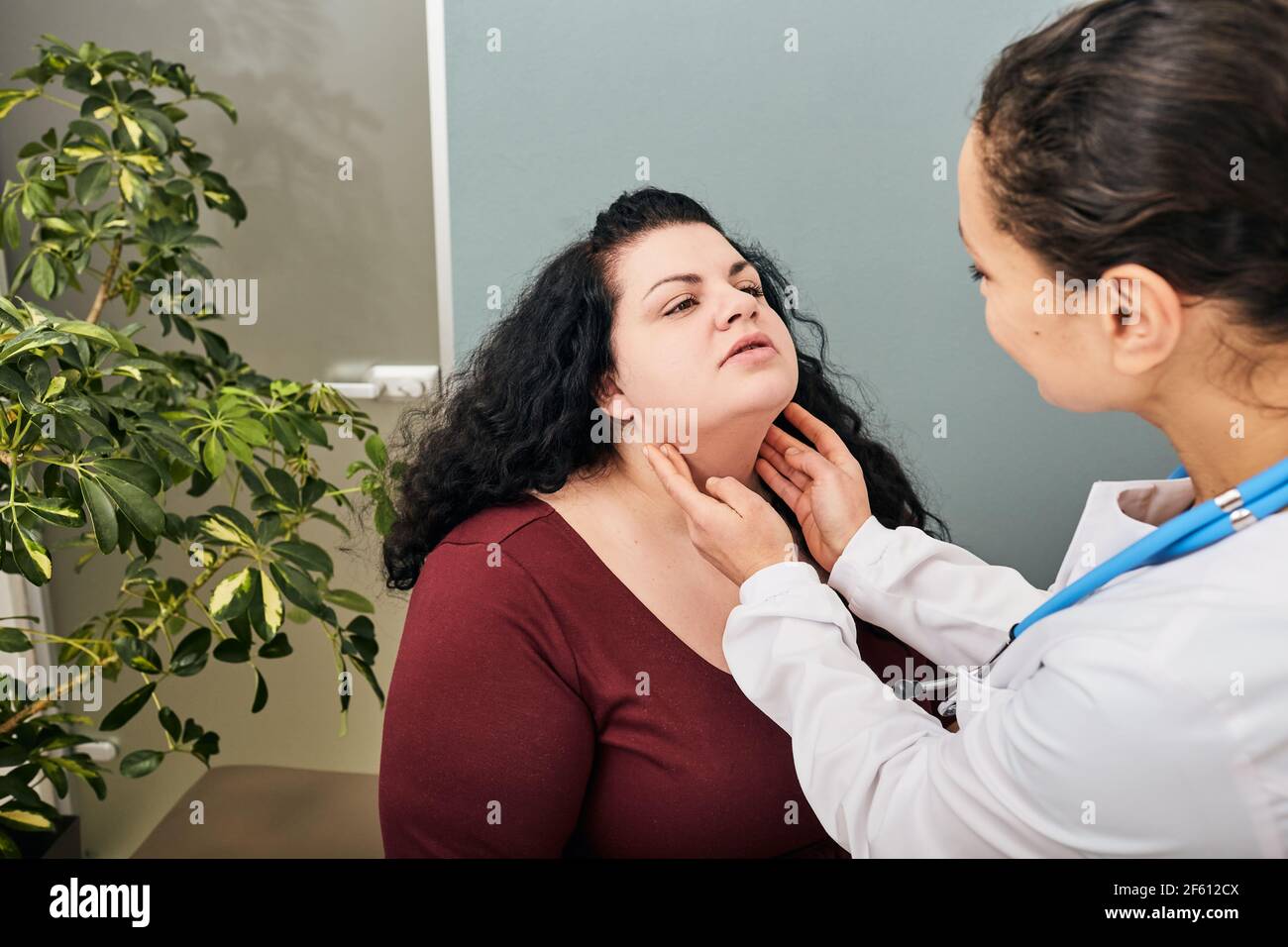 Exam of fat woman's neck for diagnostics of thyroid diseases and ...