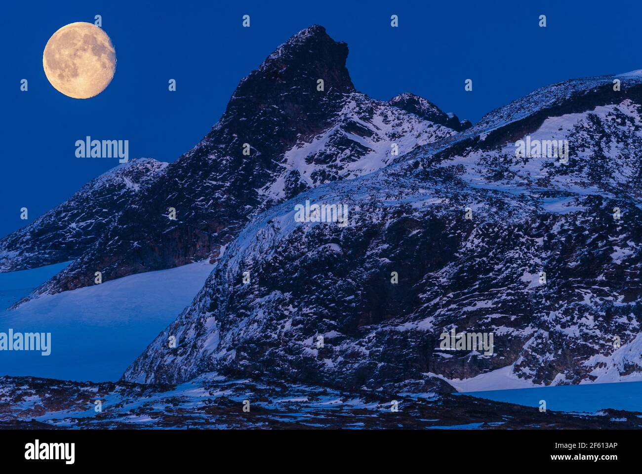 Mountain scenery with full moon at dusk Stock Photo - Alamy