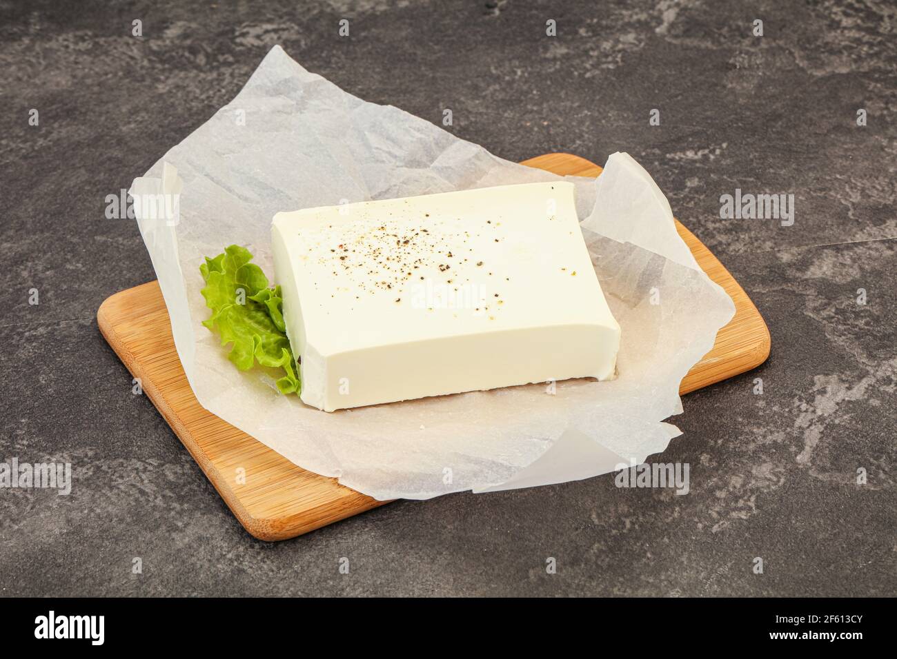 Greek cheese feta over board, still-life Stock Photo - Alamy