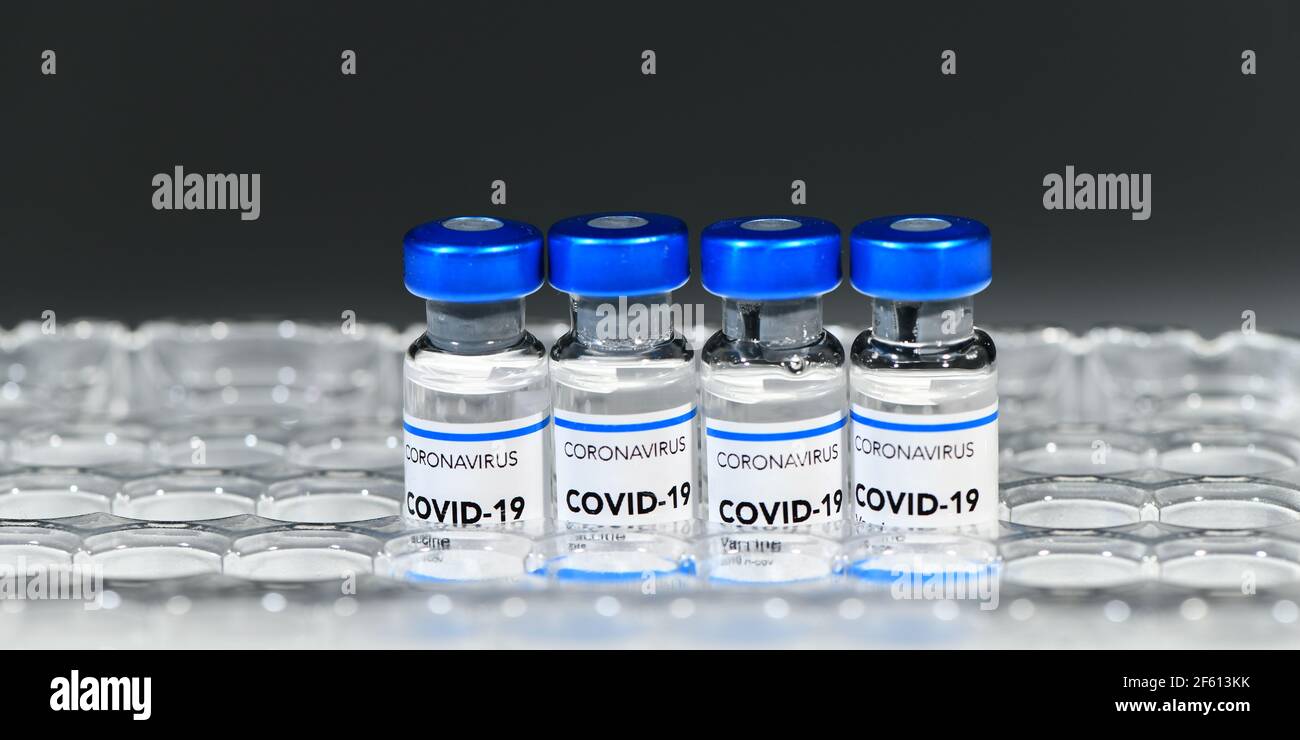 Coronavirus vaccine: covid-19 bottles vaccination: some blue-labeled ...