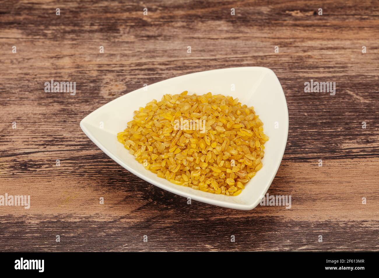 Vegetarian cuisine - dry bulgur for cooking in the bowl Stock Photo - Alamy