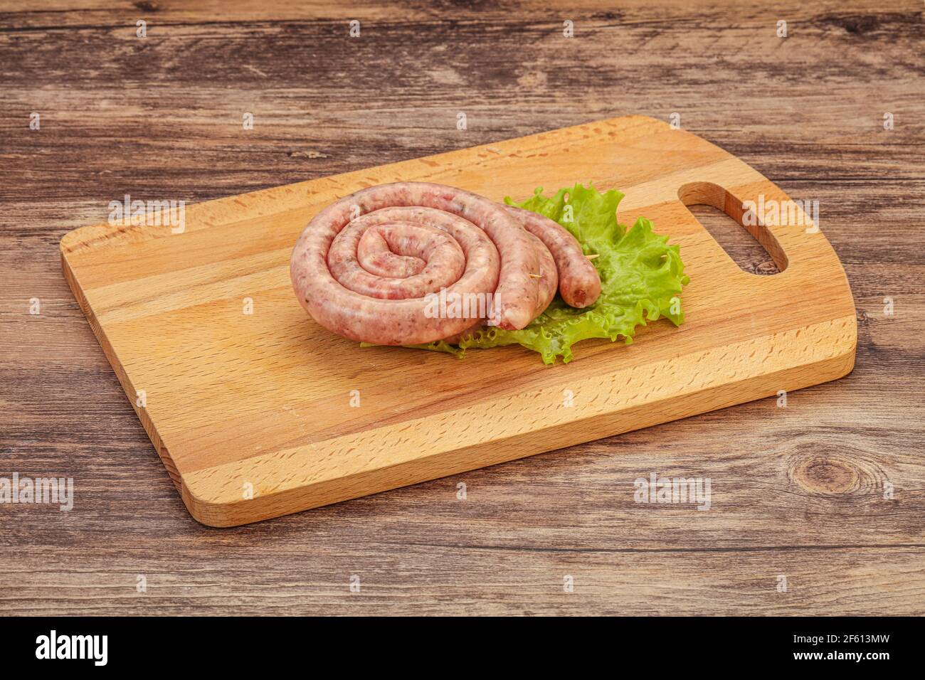 Raw pork sausage ring for grill Stock Photo - Alamy