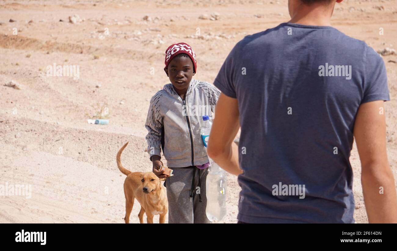 helping an african kid Stock Photo - Alamy