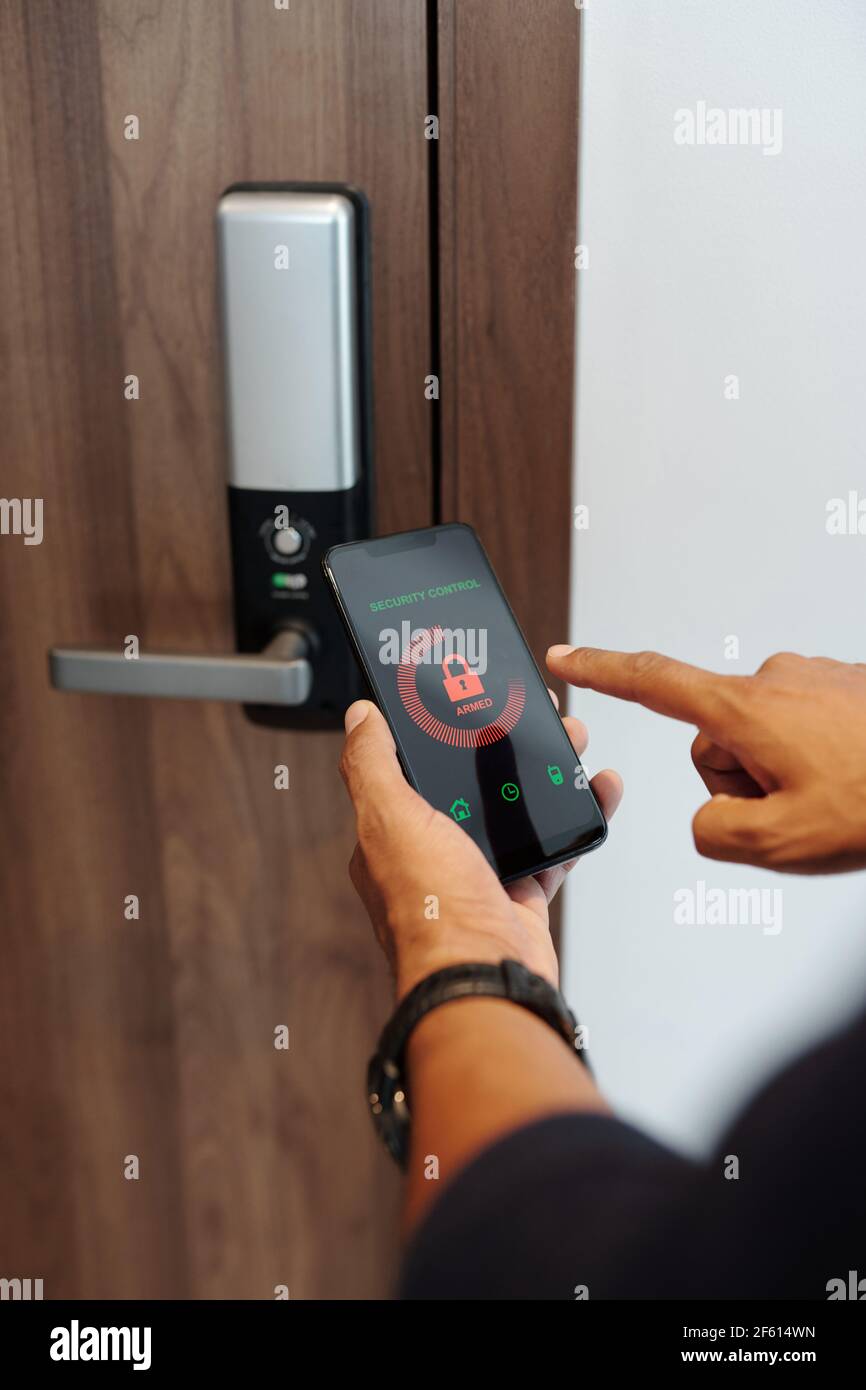 Hands man using security control application on smartphone when locking ...