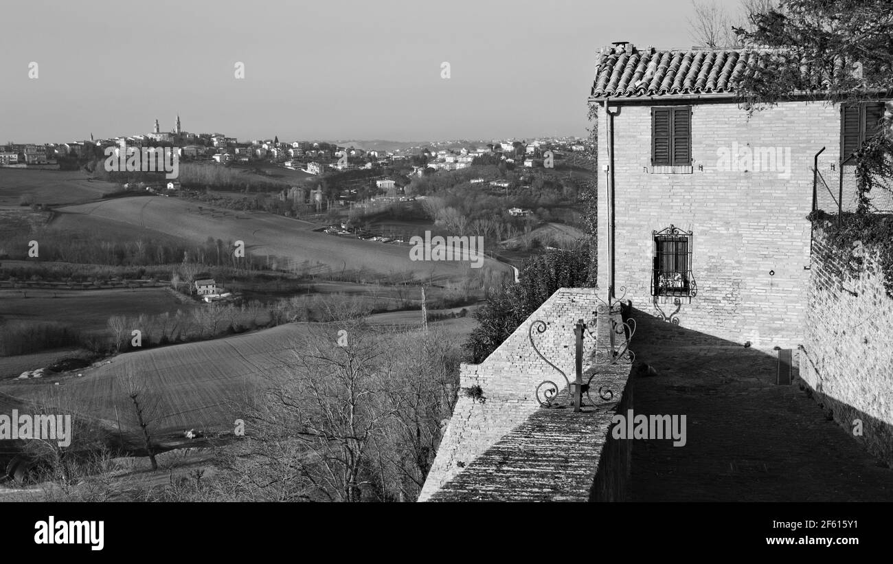 The walls of a medieval Italian village with brick buildings and a ...