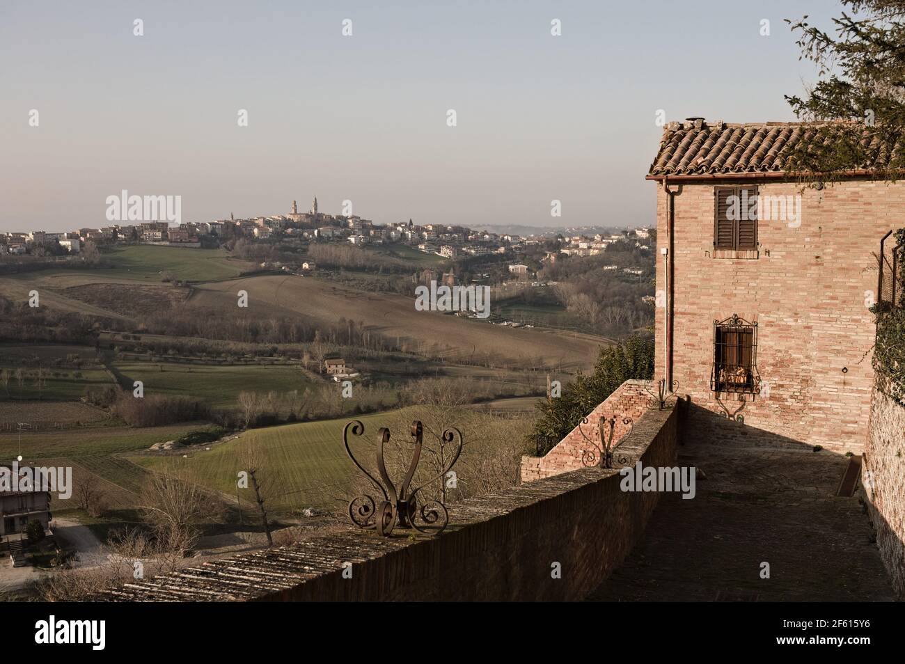 The walls of a medieval Italian village with brick buildings and a ...