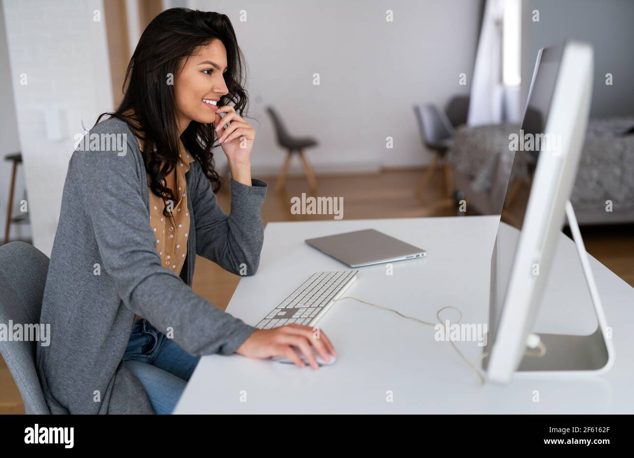 Attractive business woman working on computer. Business technology ...