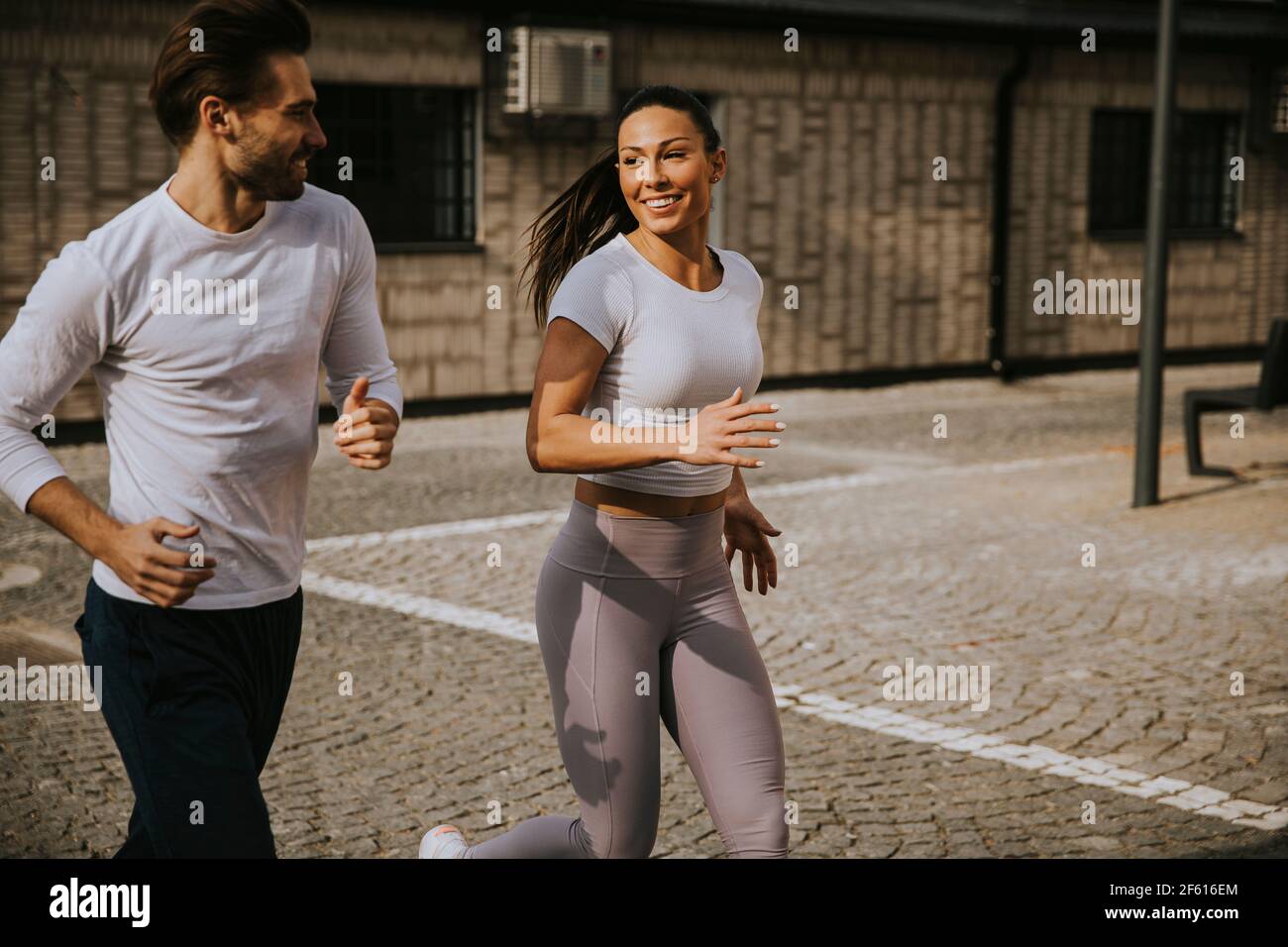 Adult adults man male woman female couple jogger runner runners hi-res ...