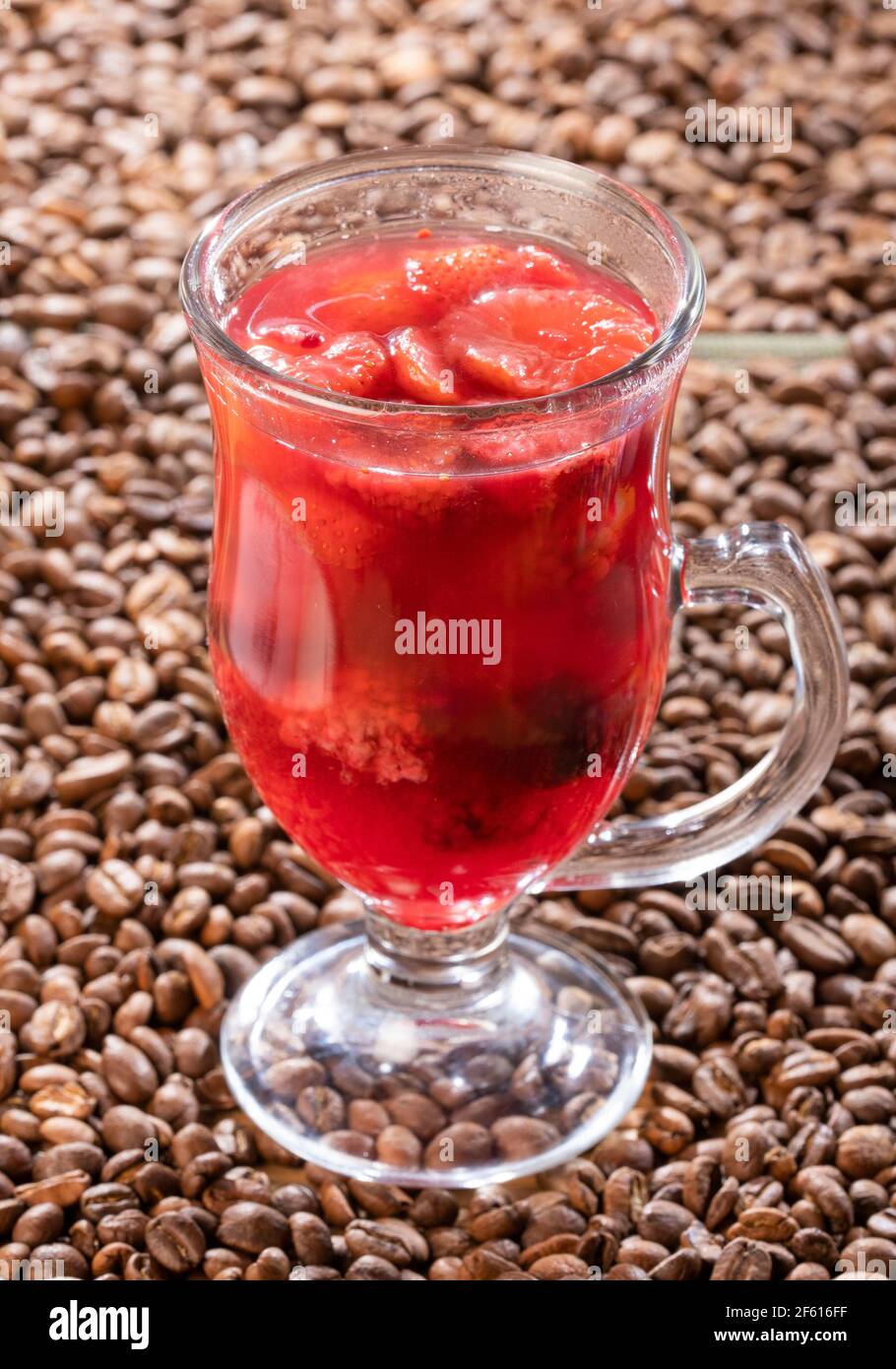 Red fruit tea - Coffee beans background Stock Photo - Alamy