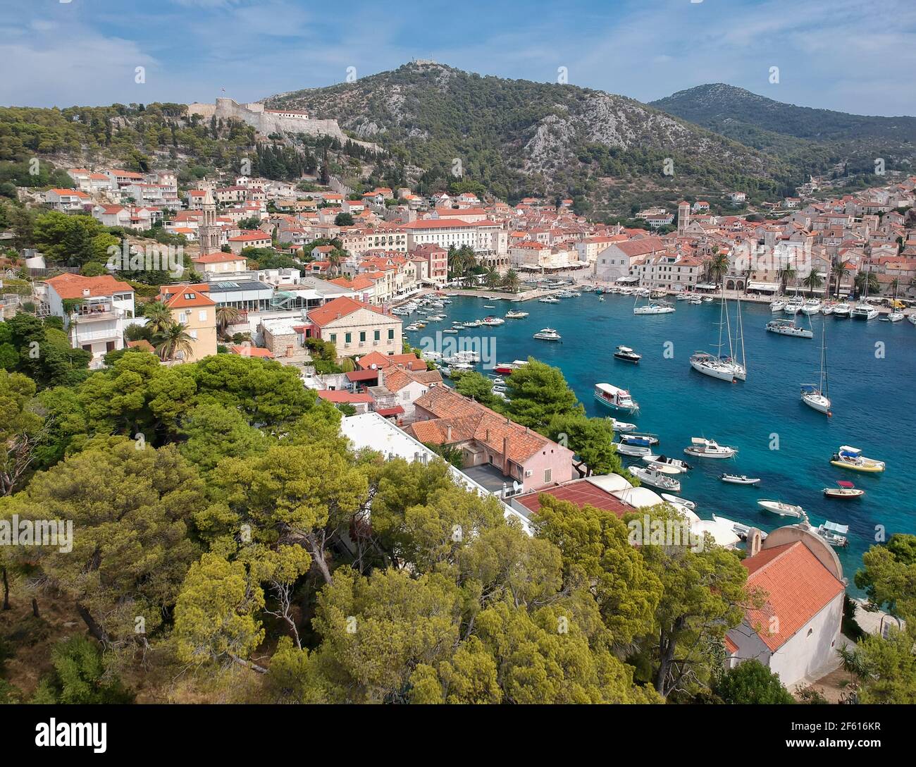 Port of Hvar with the old city and Hvar castle in the distance Stock ...