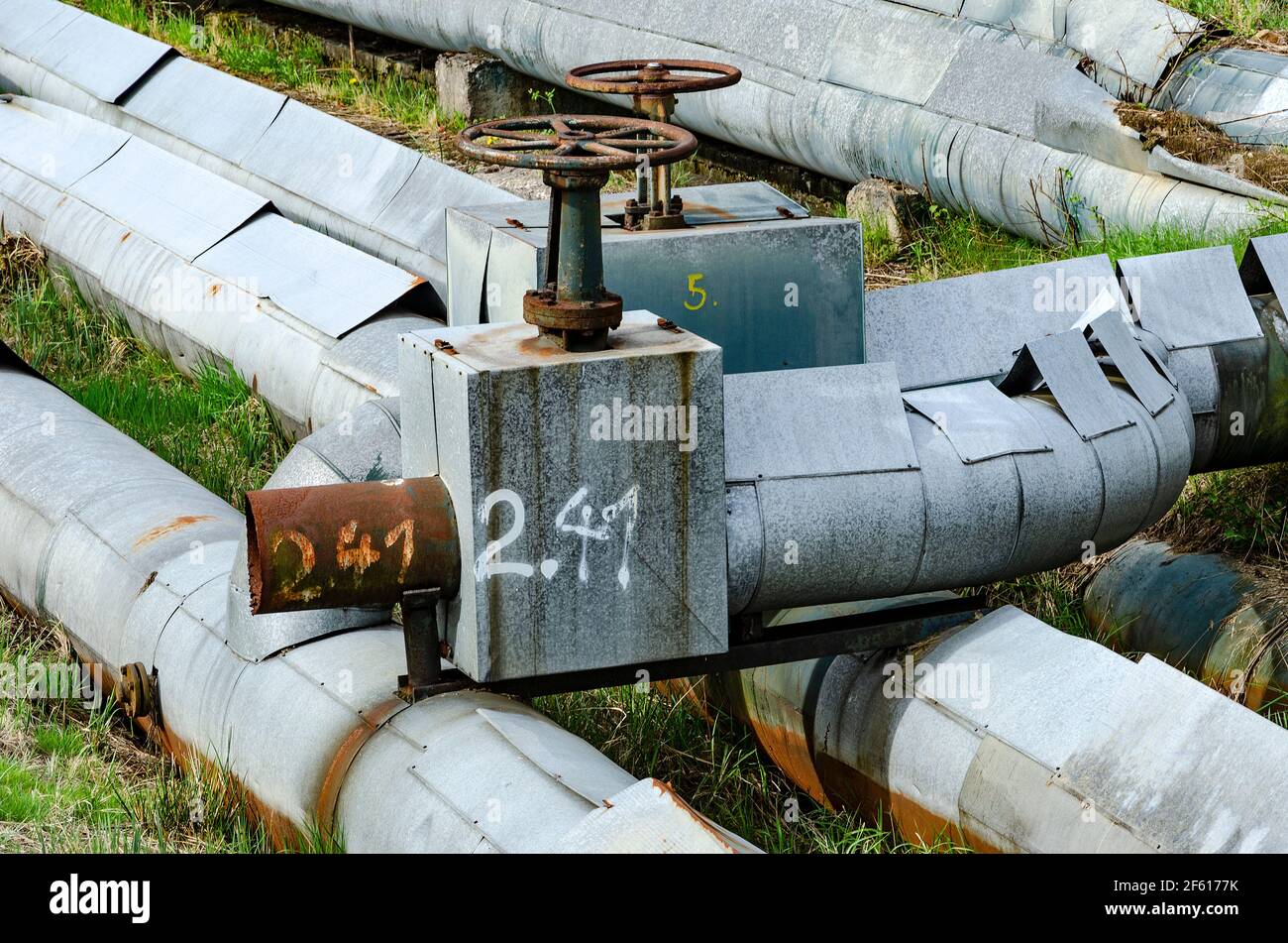 Abandoned industrial complex, rusted and broken metal pipes, locking ...