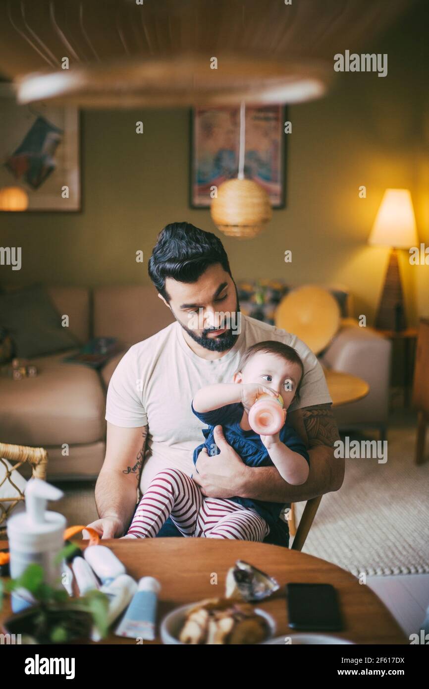 Daughter sitting on fathers lap hi-res stock photography and images - Alamy