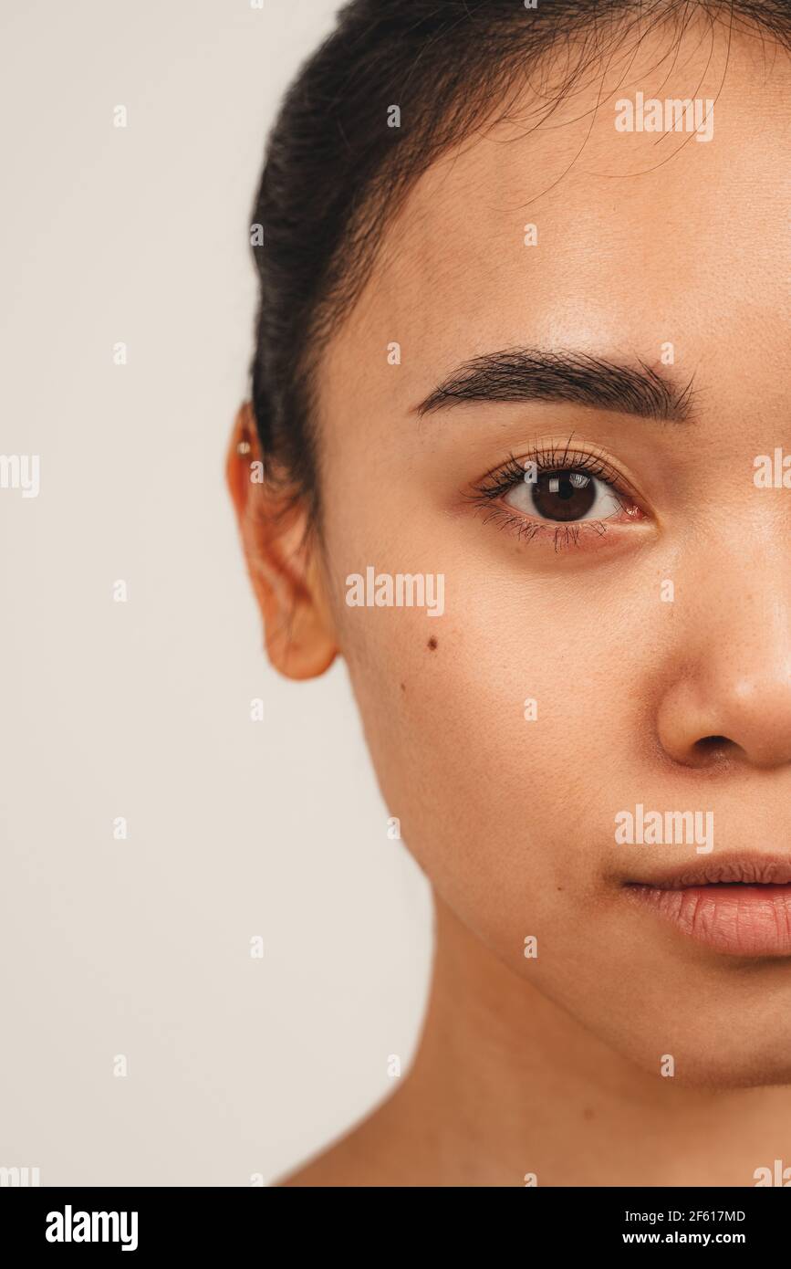 Portrait of half of face natural cute woman. Isolated over white ...