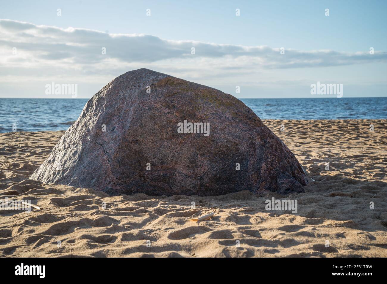 huge boulder on the sandy beach of the sea shores in the spring ...