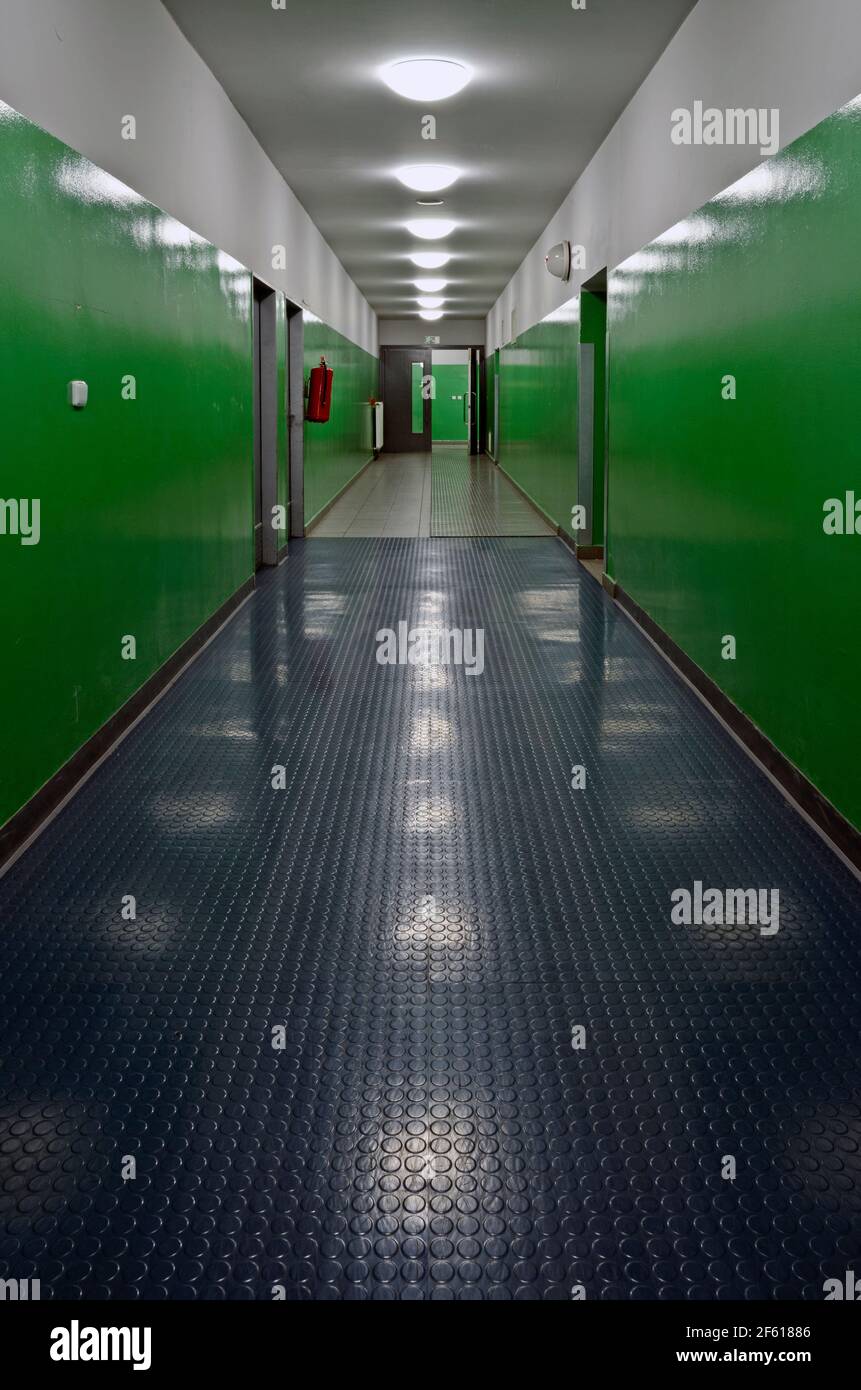 Obsolete corridor with fire extinguisher - emergency exit with glossy ...