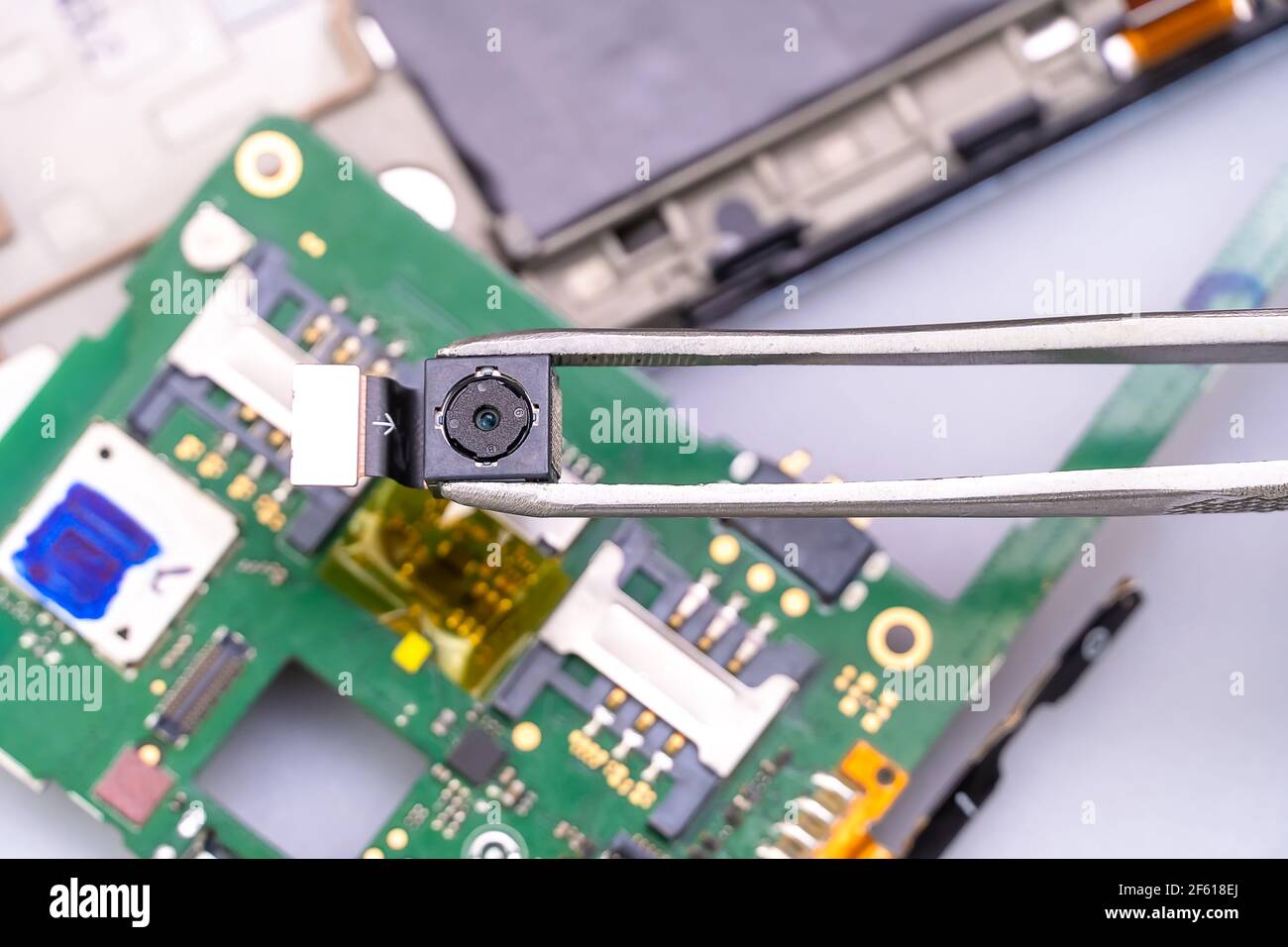 Fix the phone.A technician or master repairs a mobile phone, he ...