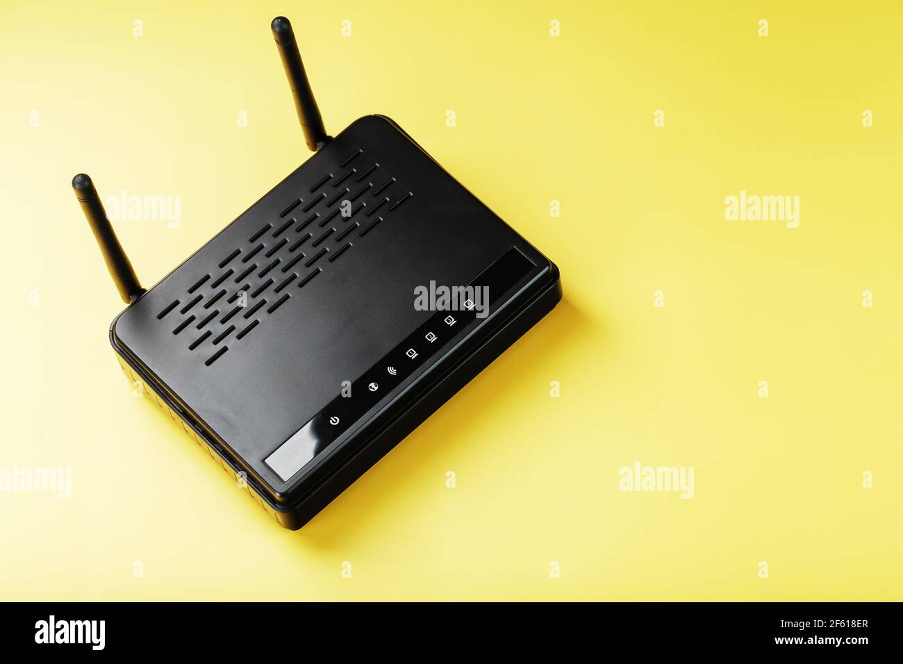 Black Wi-Fi router on a yellow background with free space. Isolate, top ...