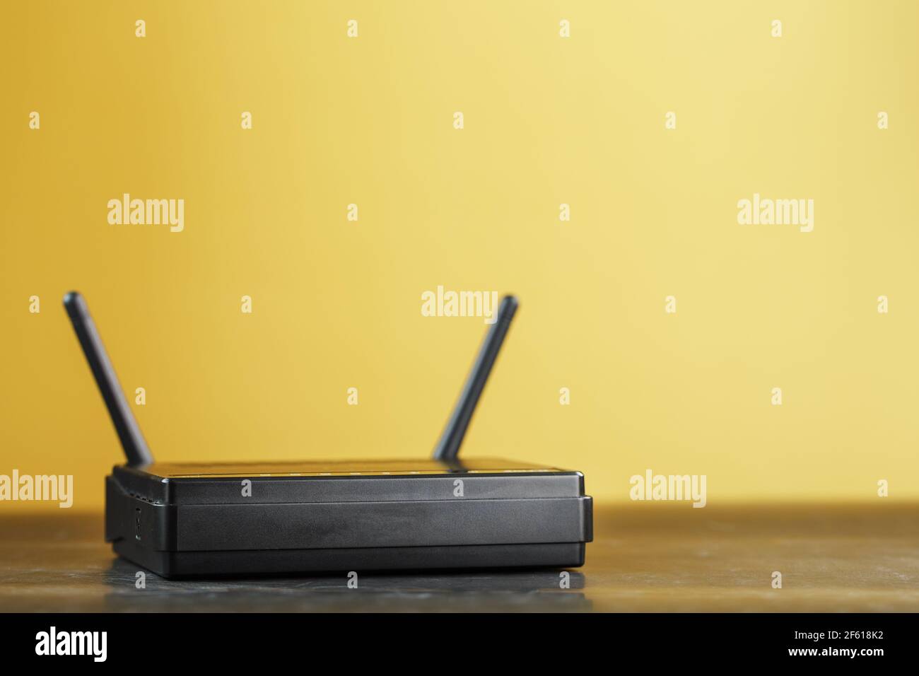 Wi-Fi router in black on a yellow background with free space. Internet ...