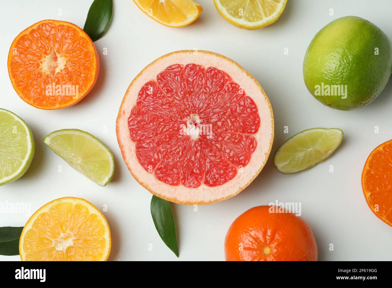 Fresh citrus with leaves on white background, top view Stock Photo - Alamy