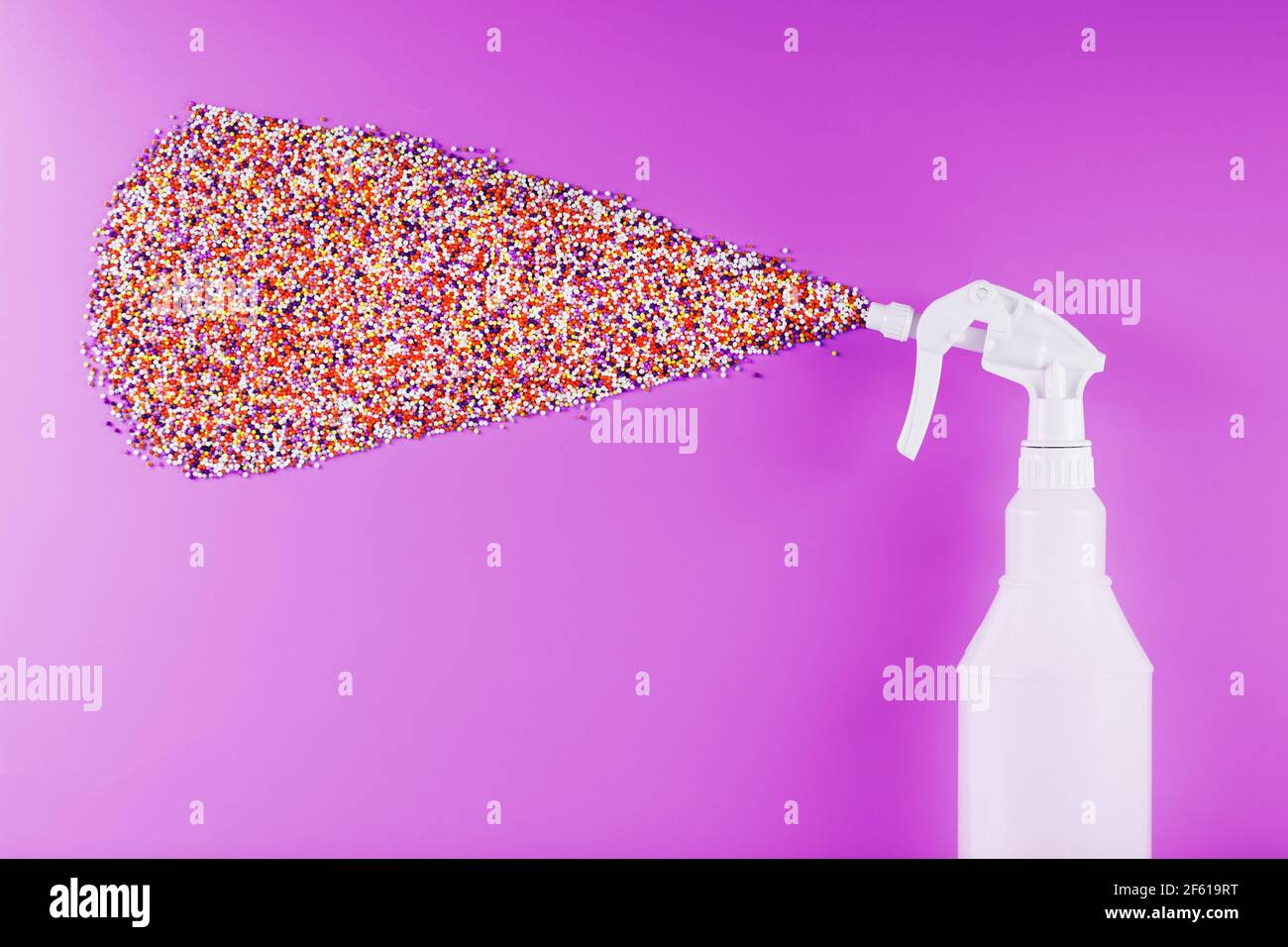 Spray splashes with colored balls on a pink background. Free space ...