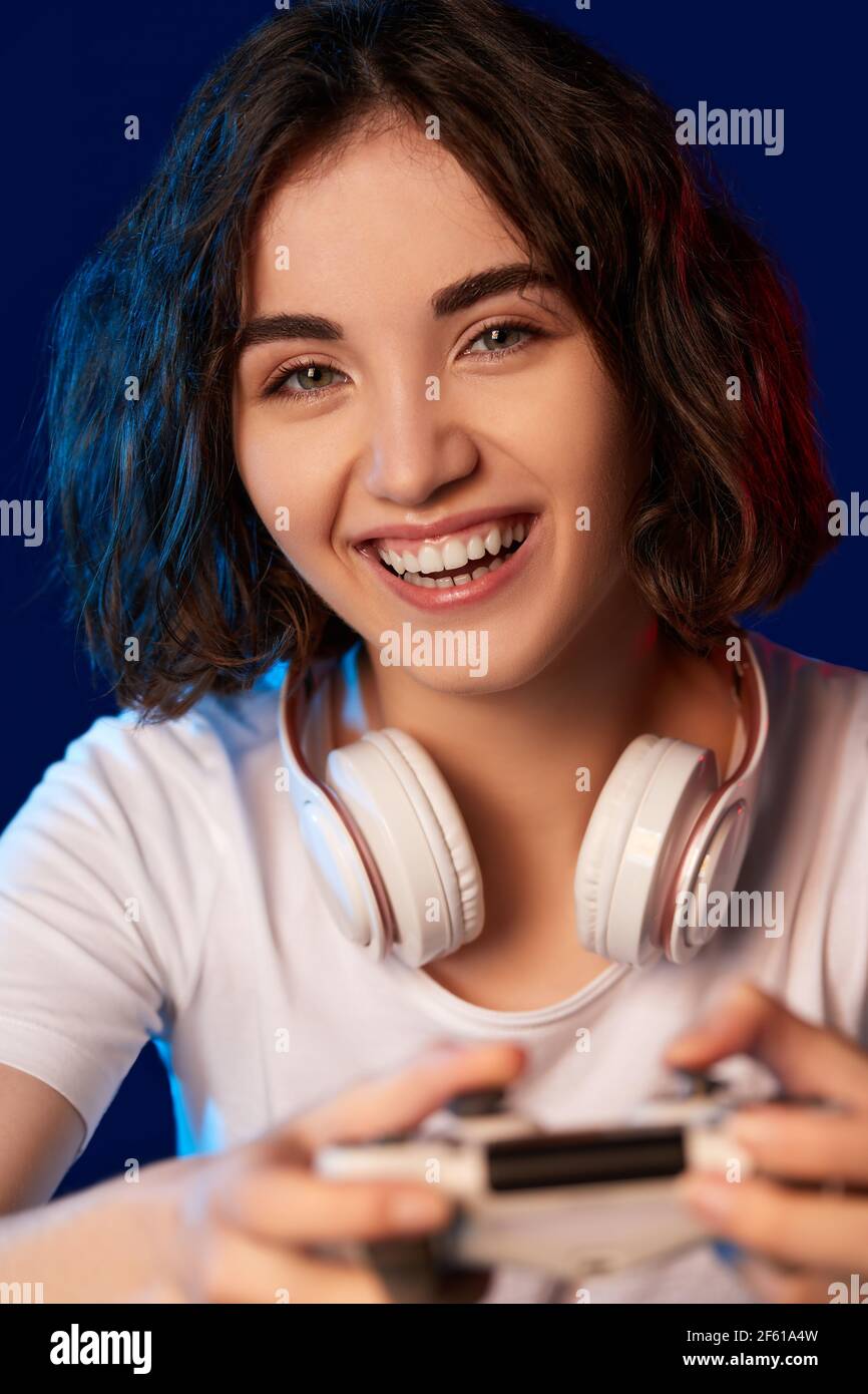 happy curly involved gamer girl playing video games Stock Photo - Alamy