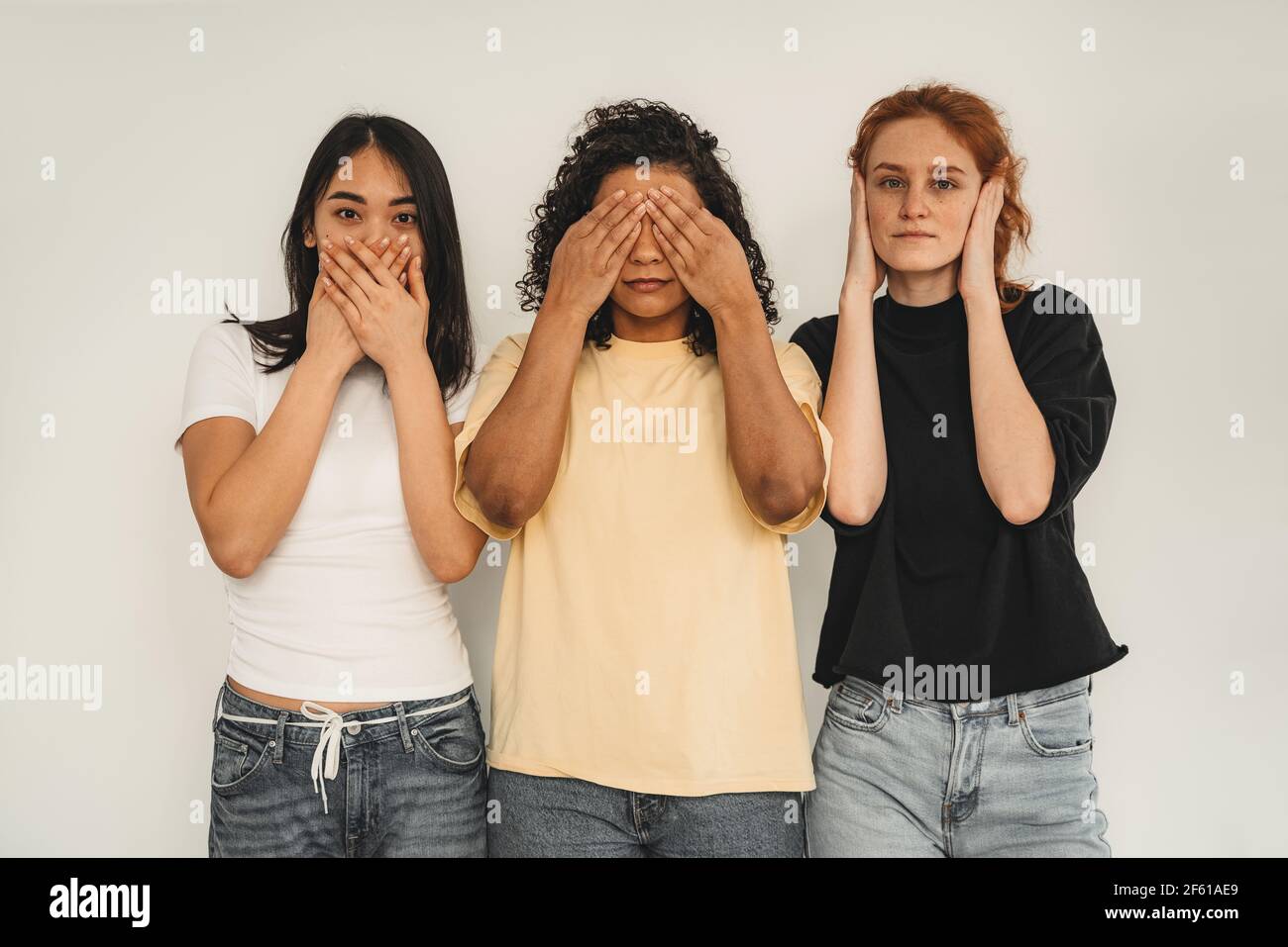 Photo of optimistic cheery young women, multiracial friends. Imitating ...