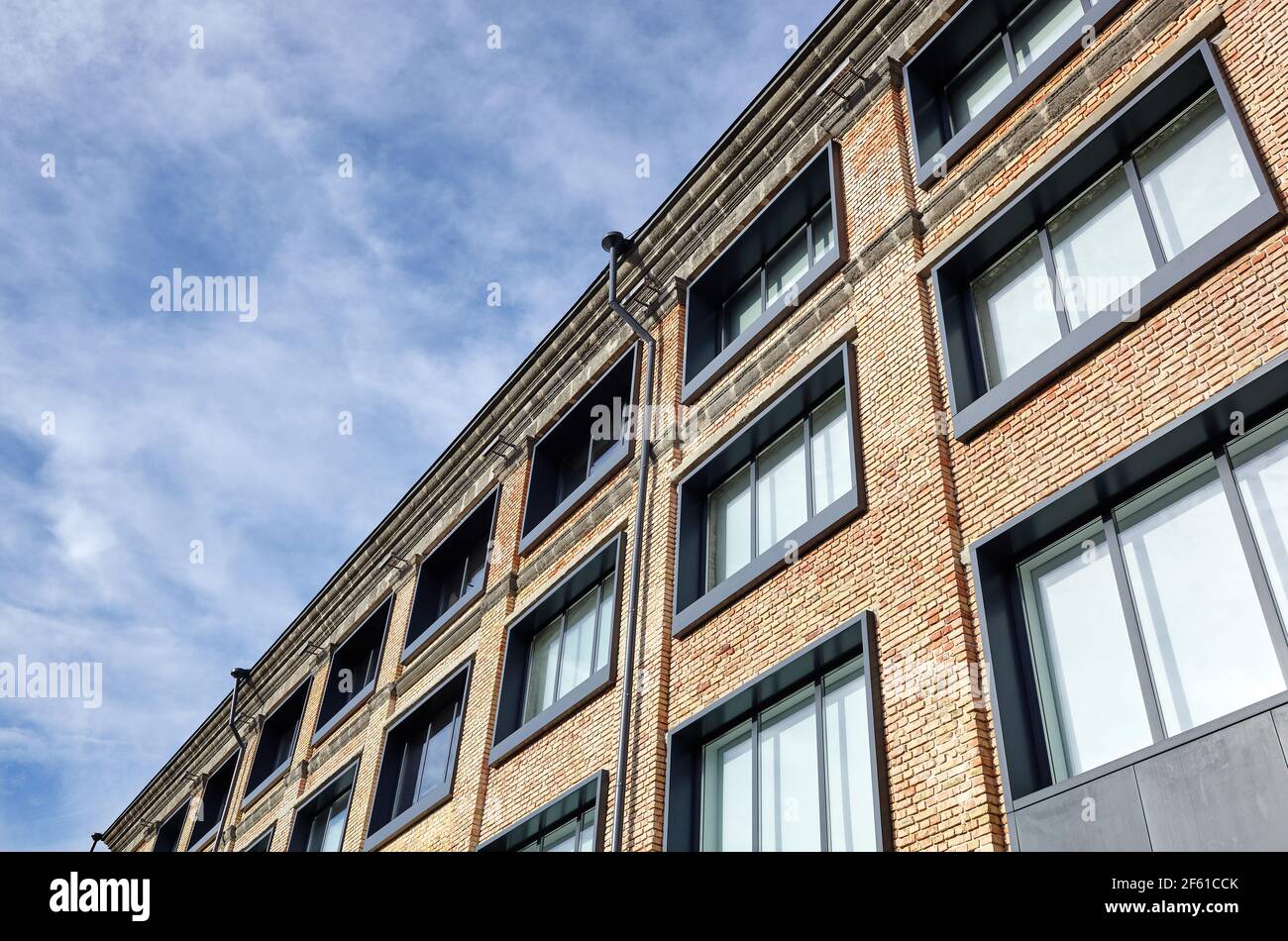 Facade of old factory building. Brick building with windows and ...