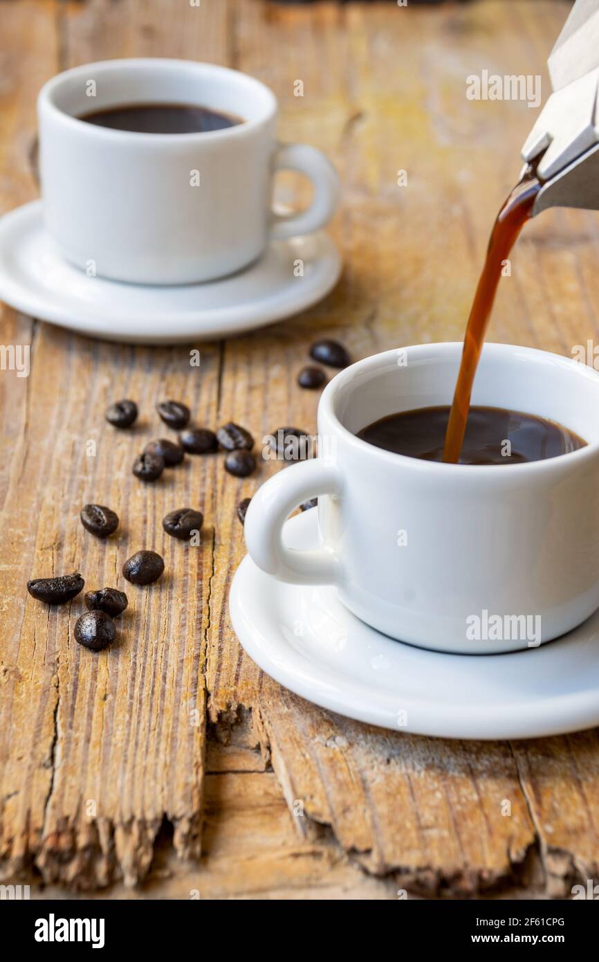 Top view of coffee pot serving in white cup, on rustic wooden table ...